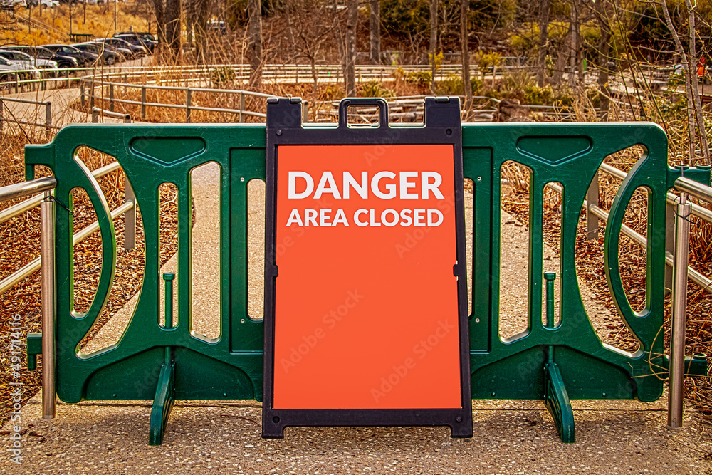 Outdoor green modular gate on public pebble and concrete sidewalk with ...