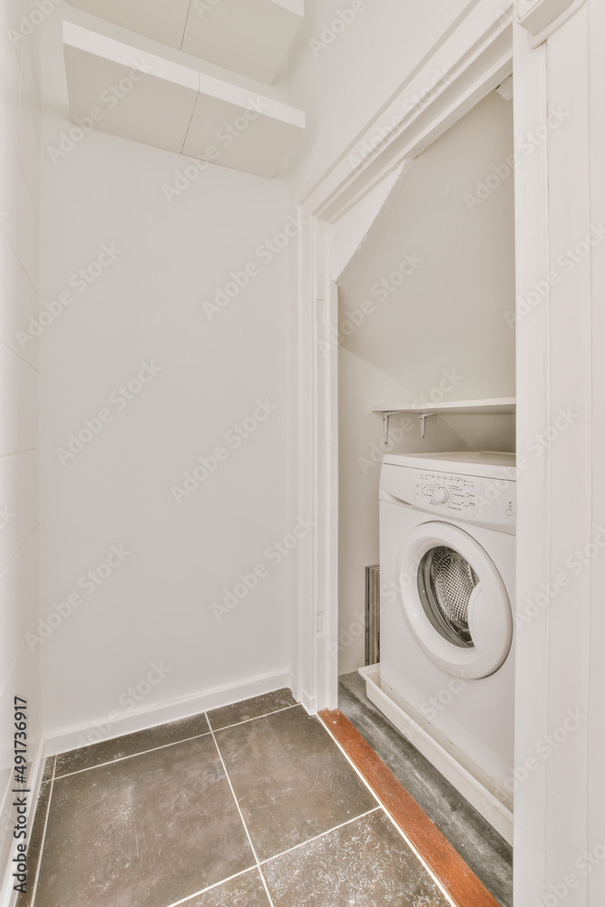 The interior of a stylish room with a wardrobe and a washing machine ...