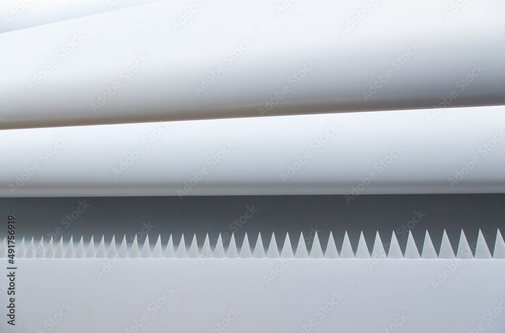 White sharp triangles that look like shark teeth stick out from a white ...