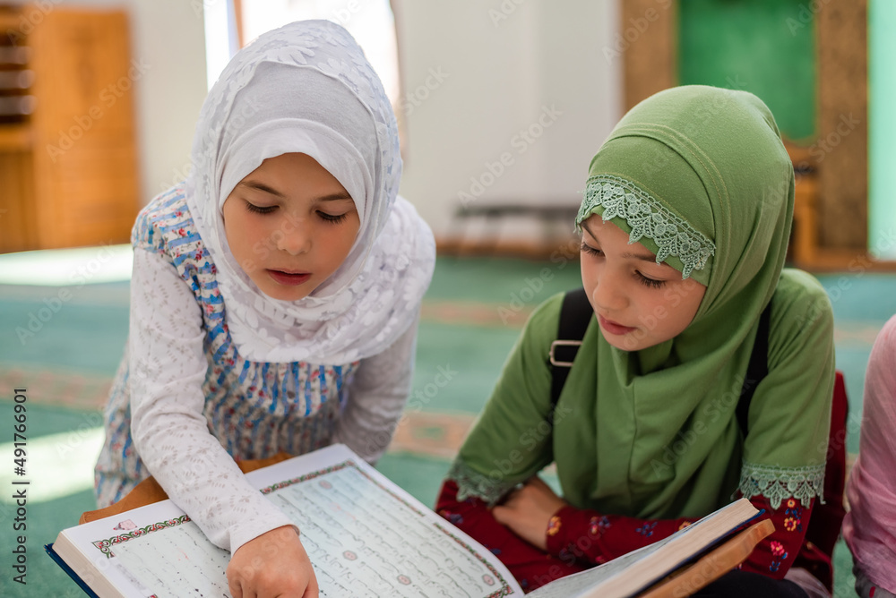 Group of a children reading a holy book Quran in the mosque. Happy ...