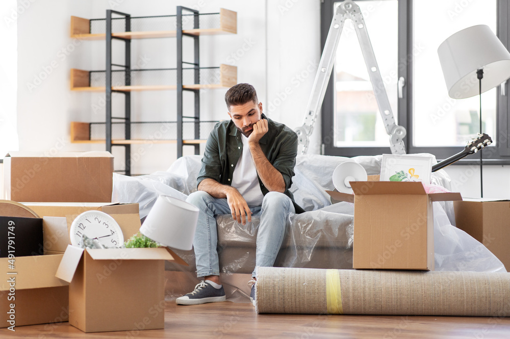 moving, eviction and real estate concept - sad man with boxes at new ...