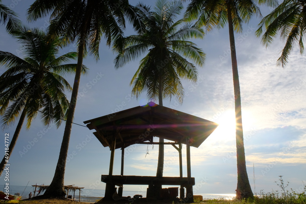 Tropical gazebo on an Irama beach with coconut palm trees at Kelantan ...