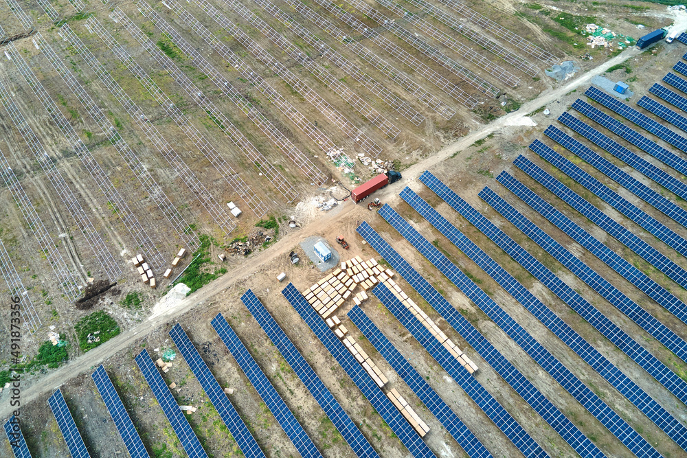 Aerial view of electrical power plant under construction with truck ...