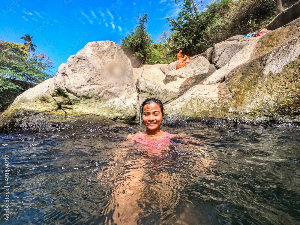 Tourist enjoying the beautiful hot spring waterfall of El Salto de ...