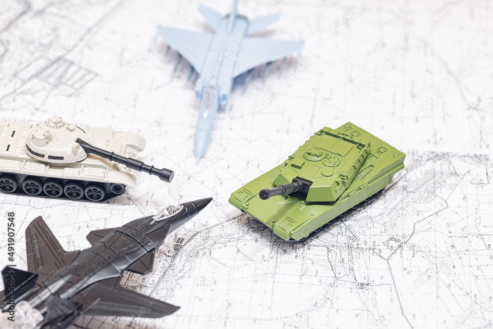 Planning a military operation on a map of the terrain using figures of ...