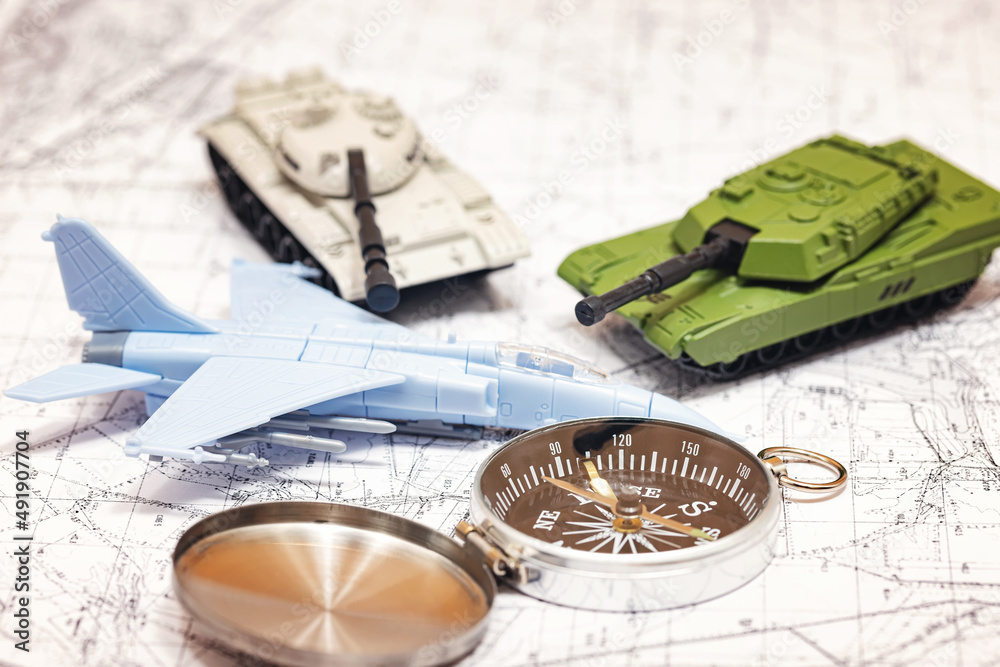 Planning a military operation on a map of the terrain using figures of ...