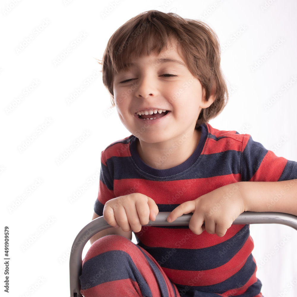 little boy making funny expressions and posing with many faces and ...