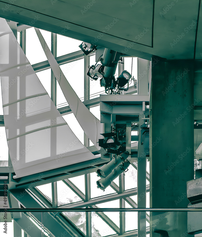 Professional grade lighting fixtures hanging in an atrium, spotlights ...