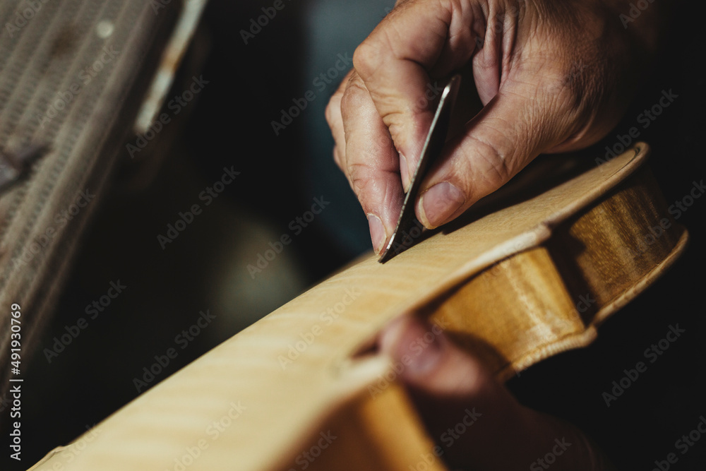 Violin maker handling luthier tools for woodcarving Stock Photo | Adobe ...
