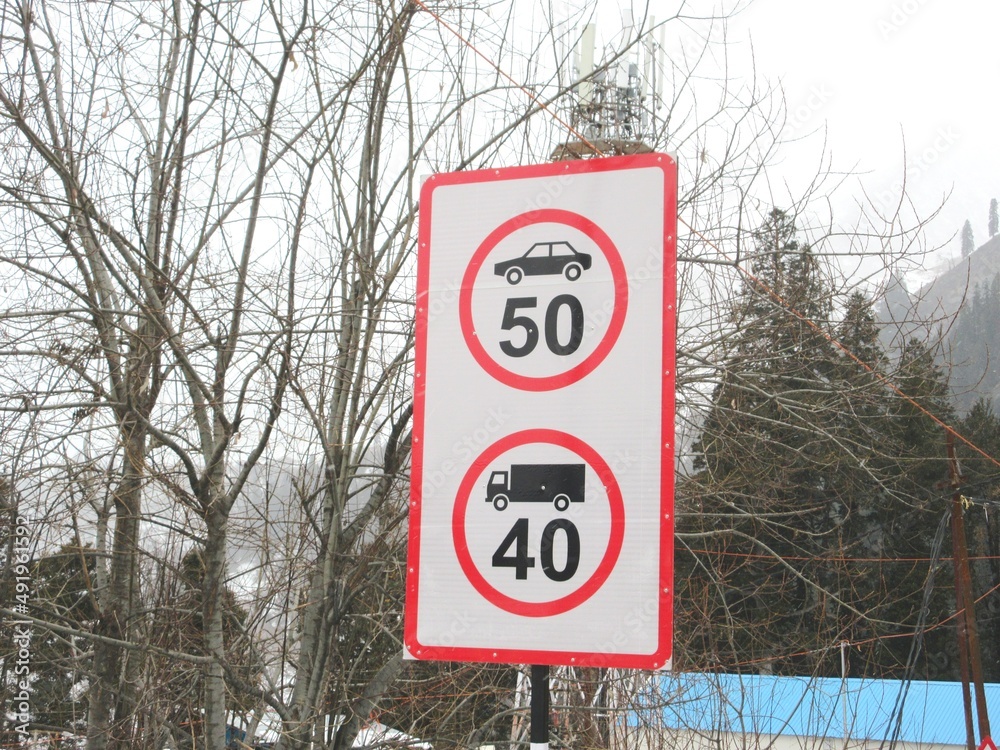 The speed limit for car and truck signboard in a mountainous region ...