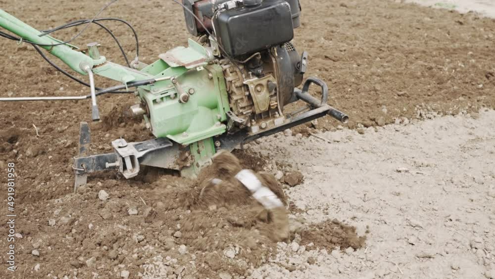 Modern farming, technology agriculture. Gardener man cultivate ground ...