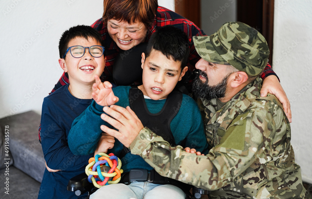Happy veteran soldier man hugging his family after returning from ...