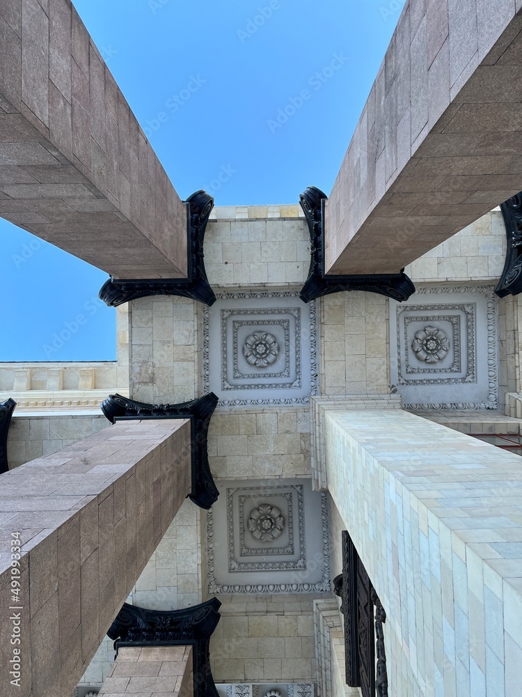 Plaster molding on a marble ceiling. Marble columns and stone ceiling ...
