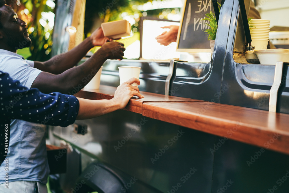Multiracial people ordering food at counter in food truck outdoor ...