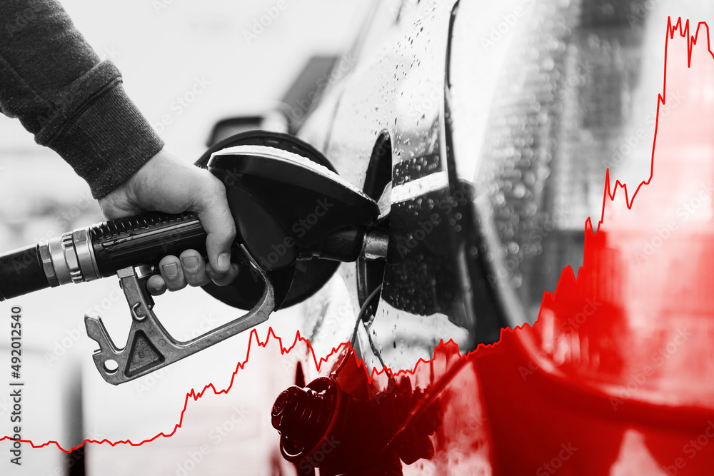 Hand with fuel nozzle and rising chart showing gasoline price increase ...