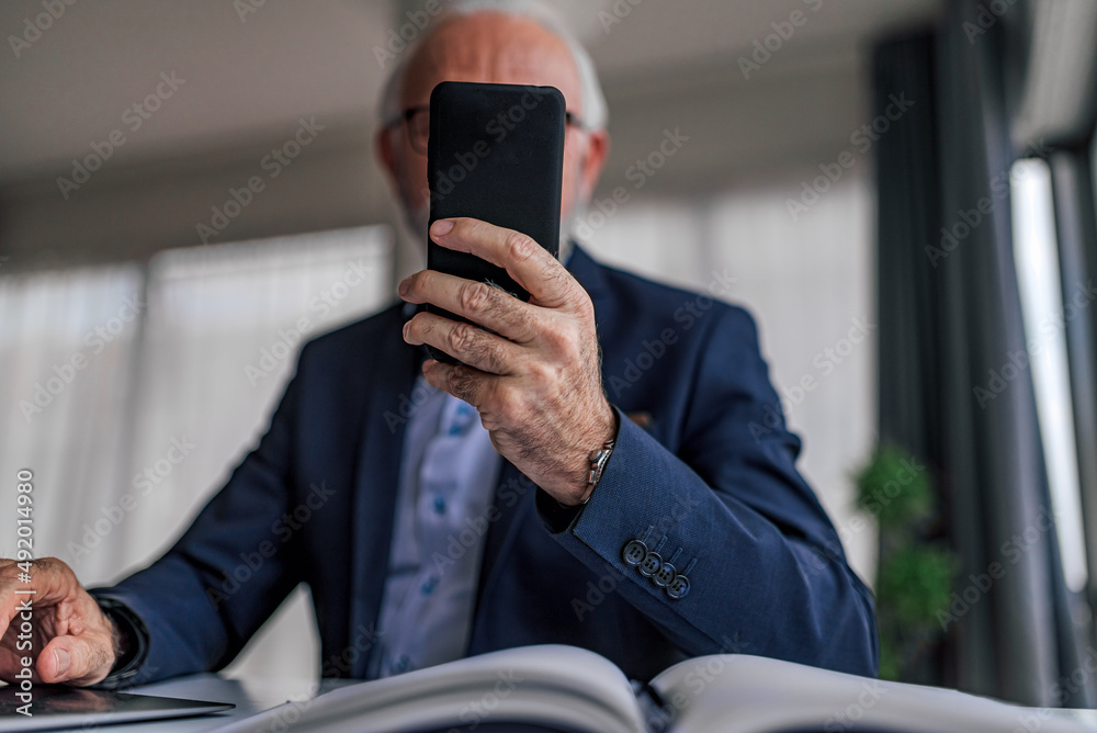 Faceless senior businessman entrepreneur holding smart phone directly ...