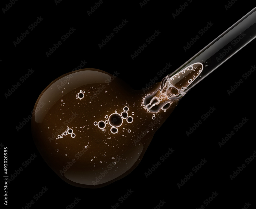 Liquid yellow-orange retinol or vitamin c gel or serum with a dropper ...
