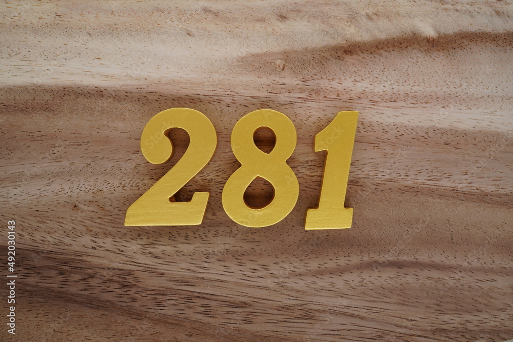Golden Arabic numerals on a real brown and white wooden floor number ...