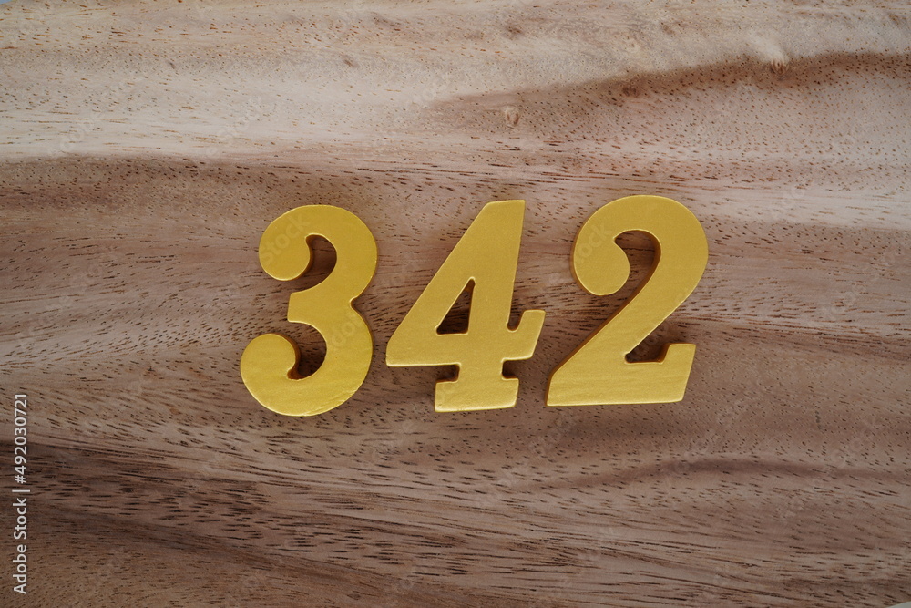 Golden Arabic numerals on a real brown and white wooden floor number ...