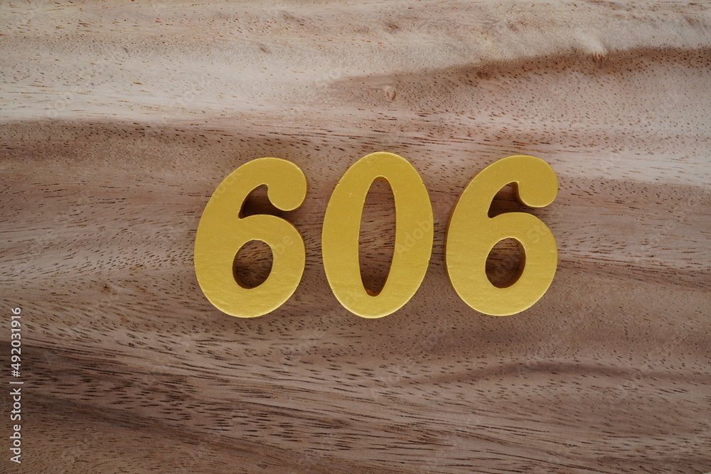 Golden Arabic numerals on a real brown and white wooden floor number ...