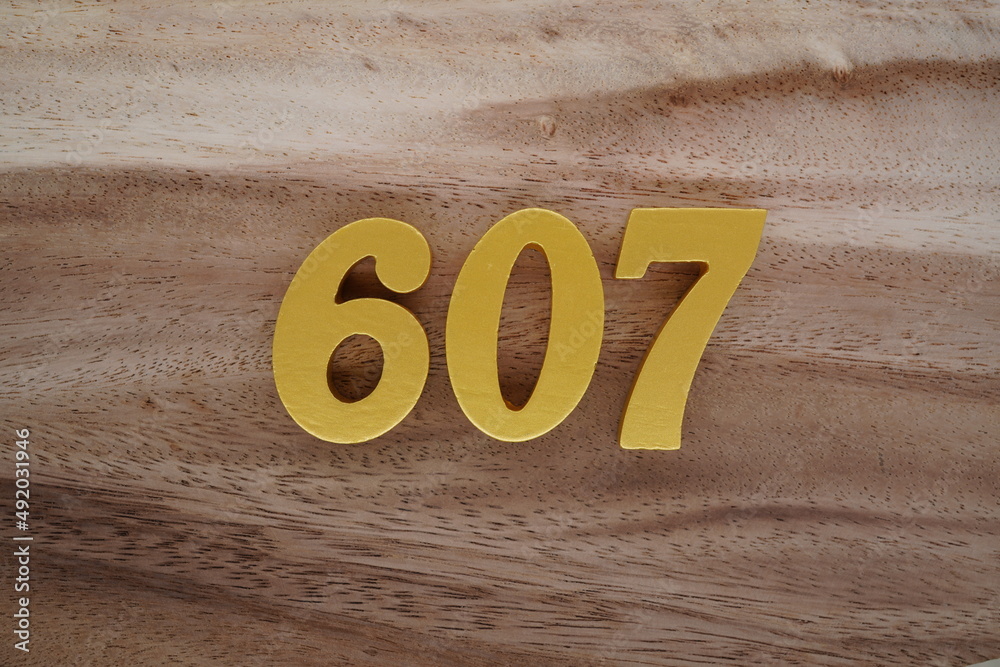 Golden Arabic numerals on a real brown and white wooden floor number ...