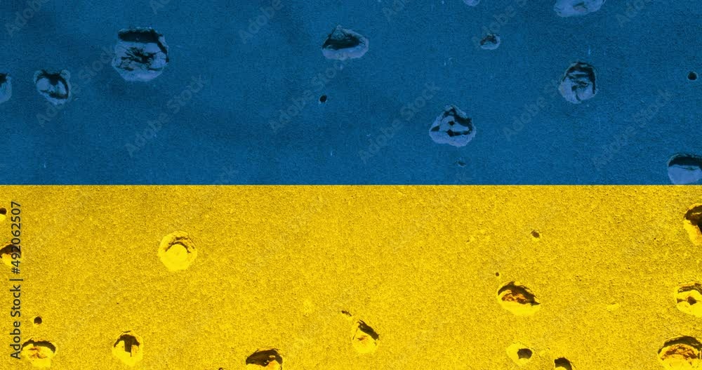 Ukrainian flag with bullet holes on the facade of a residential ...