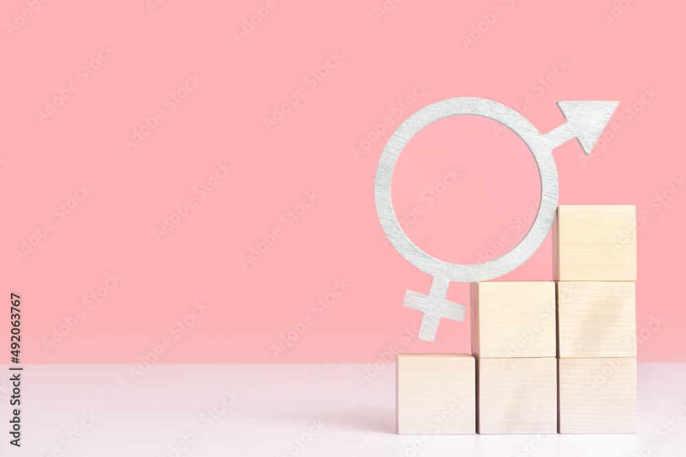The concept of gender equality, mockup on a pink background with space ...