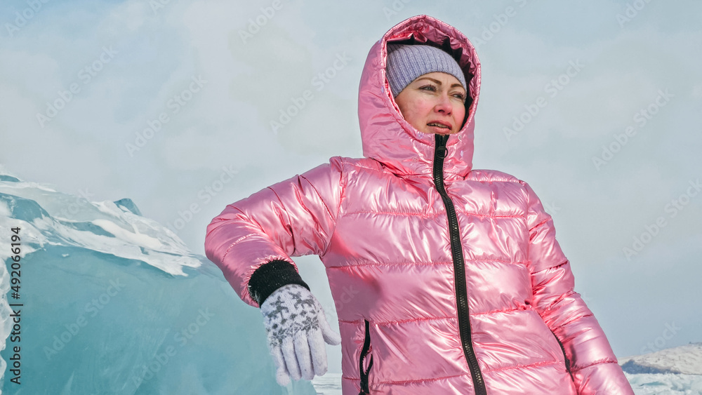 Girl walking on cracked ice of frozen lake Baikal. Woman traveler ...