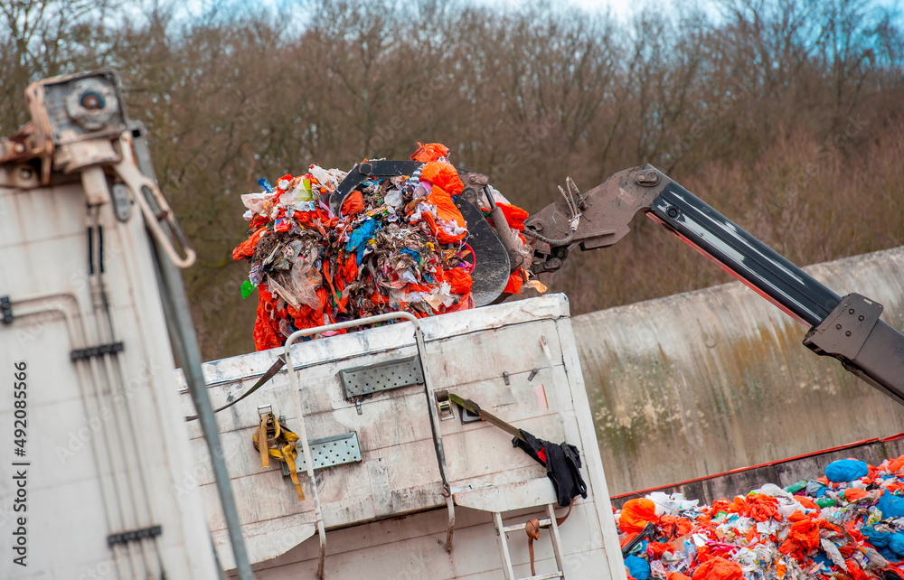 loading waste into a container Stock Photo | Adobe Stock