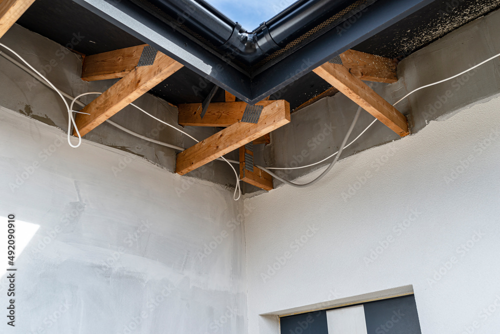 Roof trusses through which the electric cable passes to connect the ...