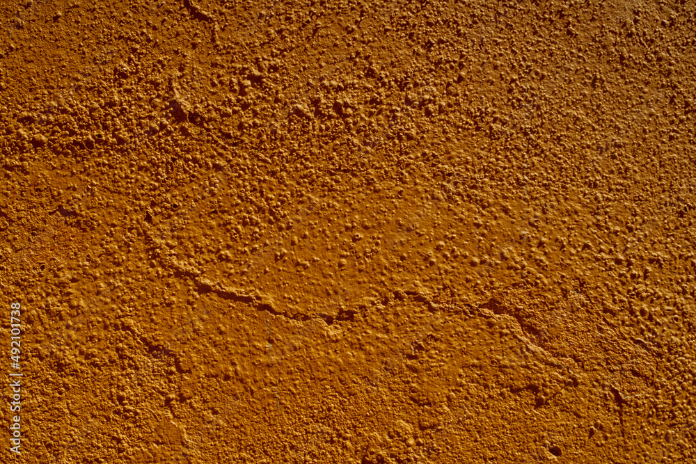 rust colored orange stucco texture wall in antique Mexican construction ...