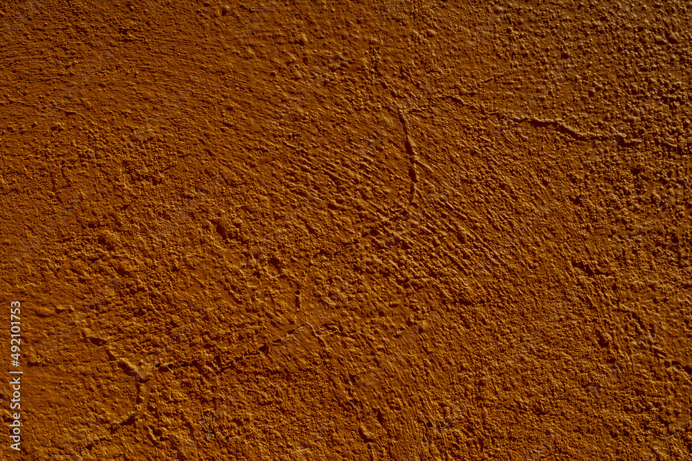 rust colored orange stucco texture wall in antique Mexican construction ...