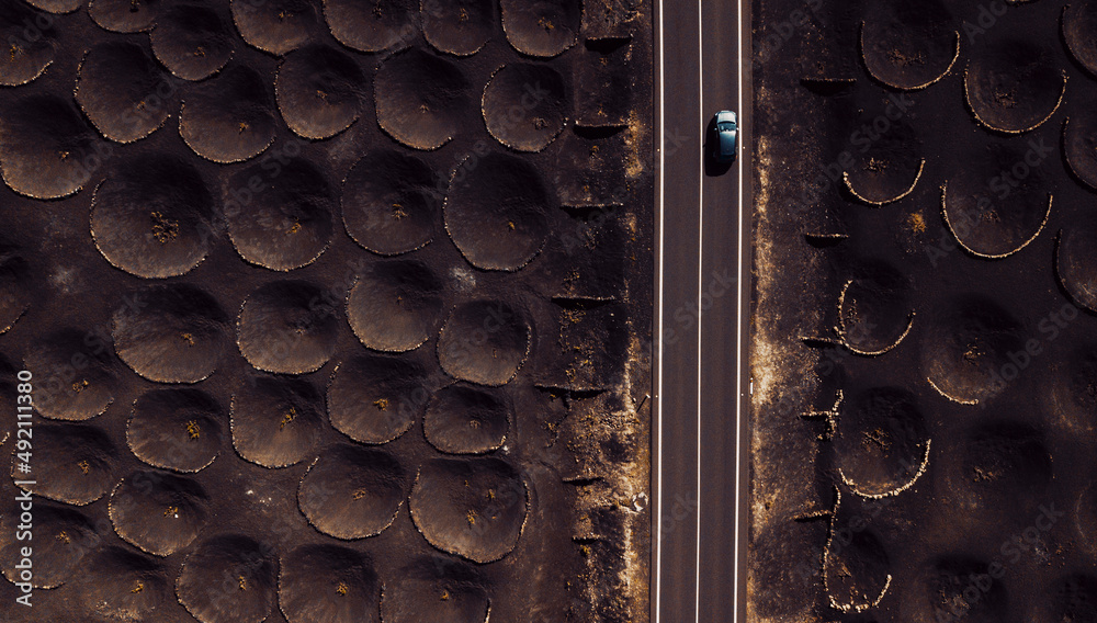 Lunar landscape concept with long asphalt road and car traveling. Rare ...