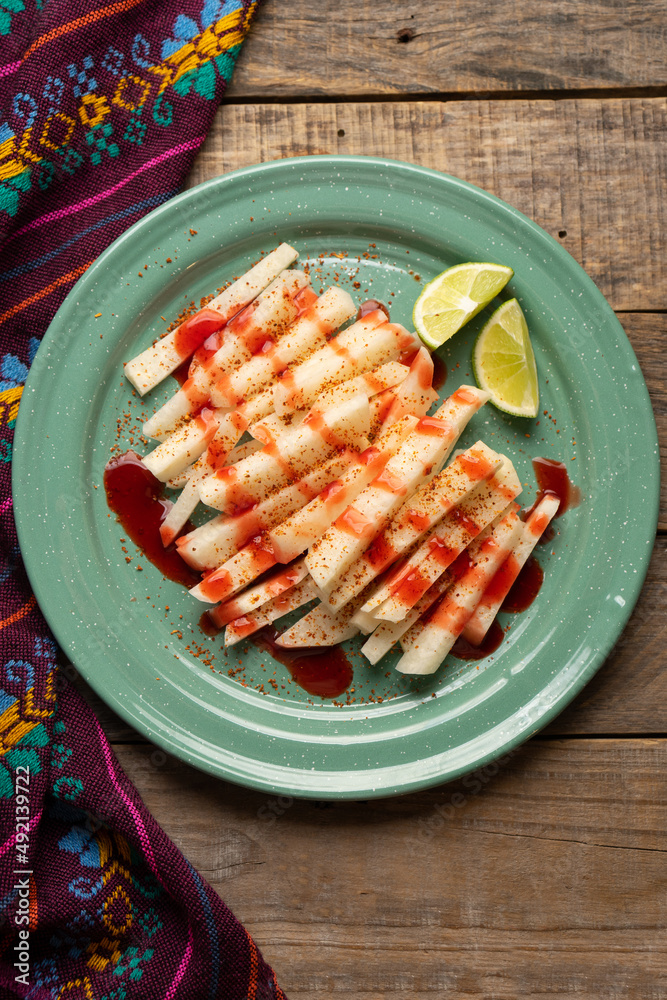 Mexican yam bean also called Jicama with chili powder and chamoy sauce ...