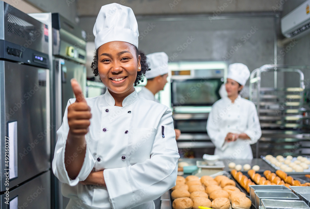 Smiling african female bakers looking at camera..Chefs baker in a chef ...