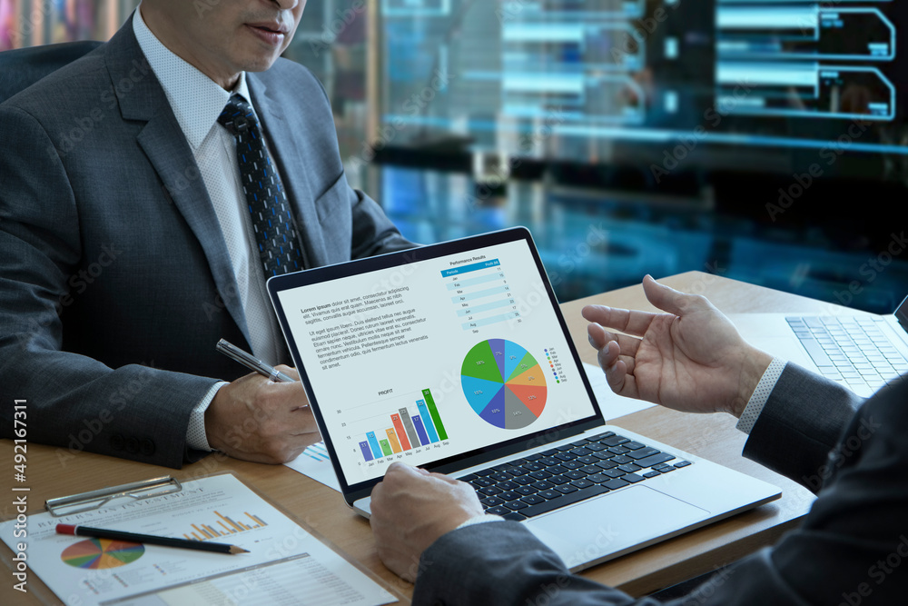 Two businessmen with laptop computer notebook in a modern office ...