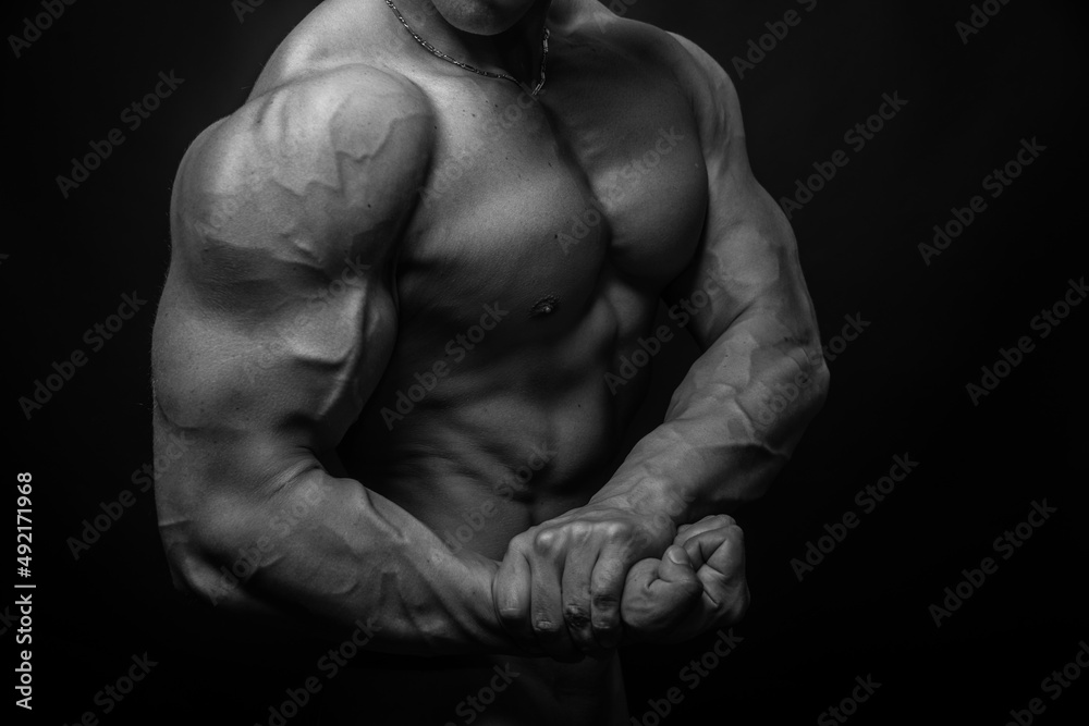 Muscled male model flexing biceps Stock Photo | Adobe Stock
