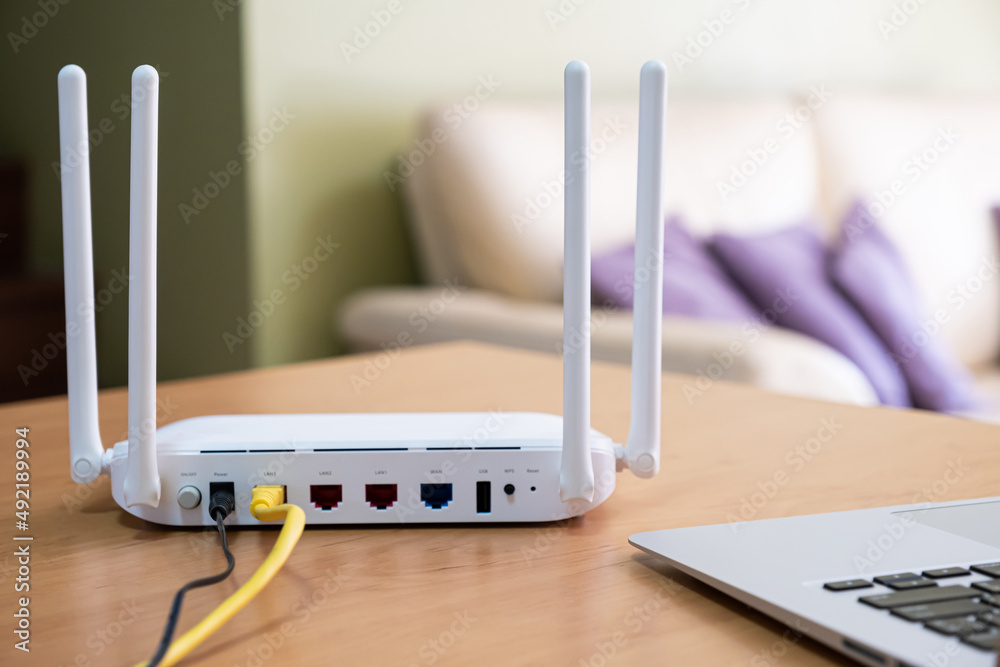 Selective focus at router. Internet router on working table with living ...