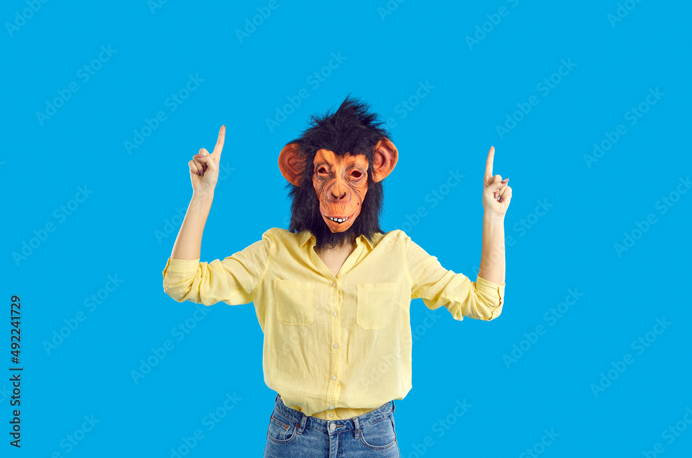 Woman with monkey face showing something above her. Young girl wearing ...