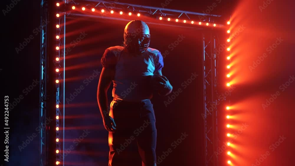 Unrecognizable confident quarterback holding ball. American football ...