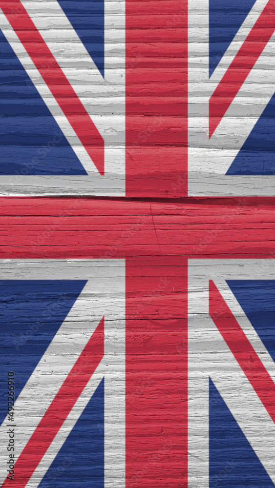 Fragment of British flag on a dry wooden surface. Natural vertical ...