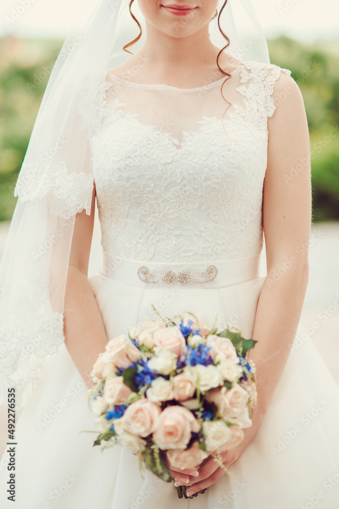 Bride in a wedding dress and with a bouquet of flowers, dress for the ...
