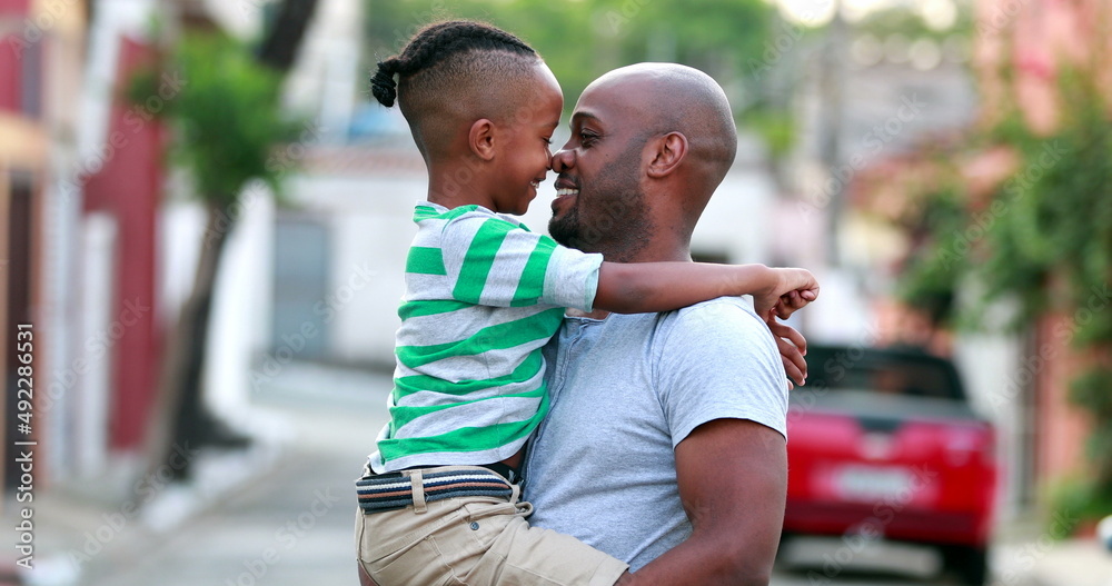 Father and son doing eskimo kiss. African black dad and child bonding ...