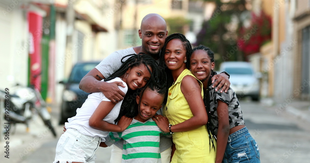 Beautiful black family embrace. Loving father hugging wife and children ...