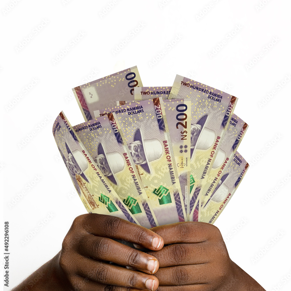 Black hands holding 3D rendered 200 Namibian dollar notes. closeup of ...