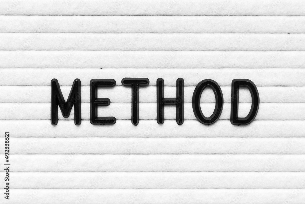 Black alphabet letter in word method on white felt board background ...