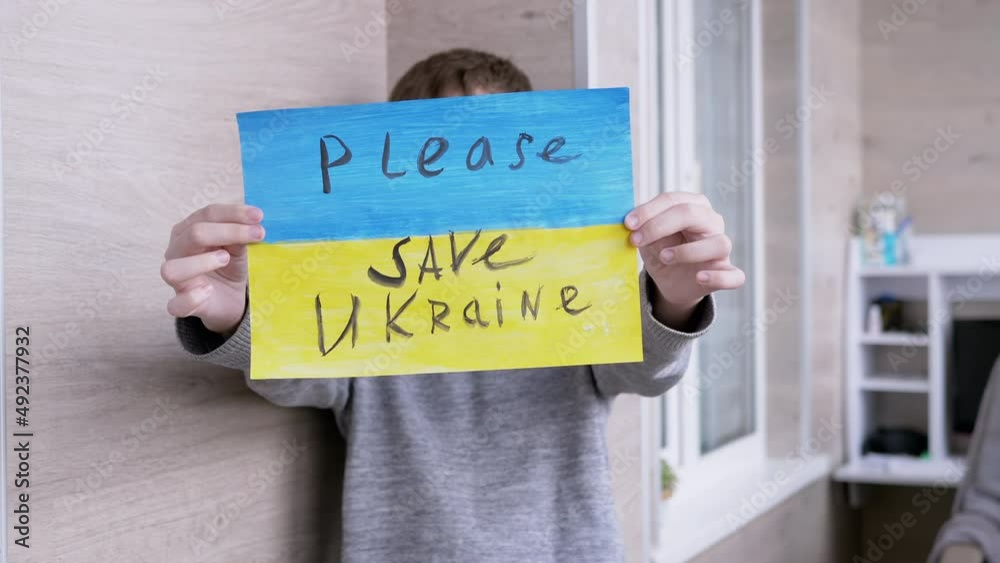 Child Holds a Banner with a Blue and Yellow Flag, Message Please Save ...
