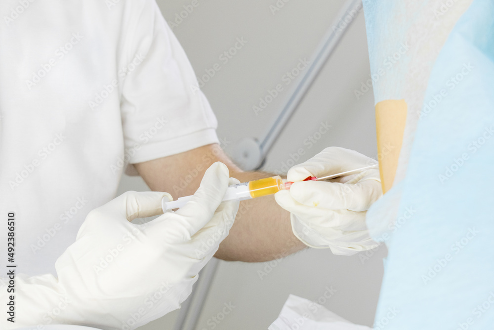 doctor giving a woman an injection in the back. The introduction of ...