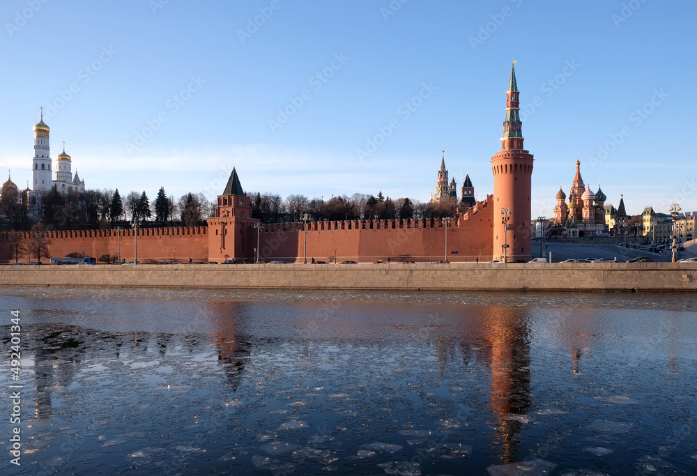 Moscow Kremlin embankment with red brick wall and towers in bright ...
