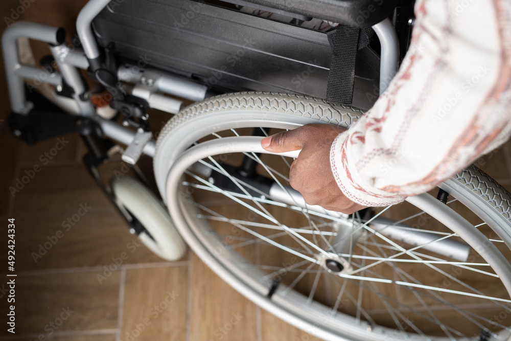 Above view of hand of young man with disability rotating wheel of ...